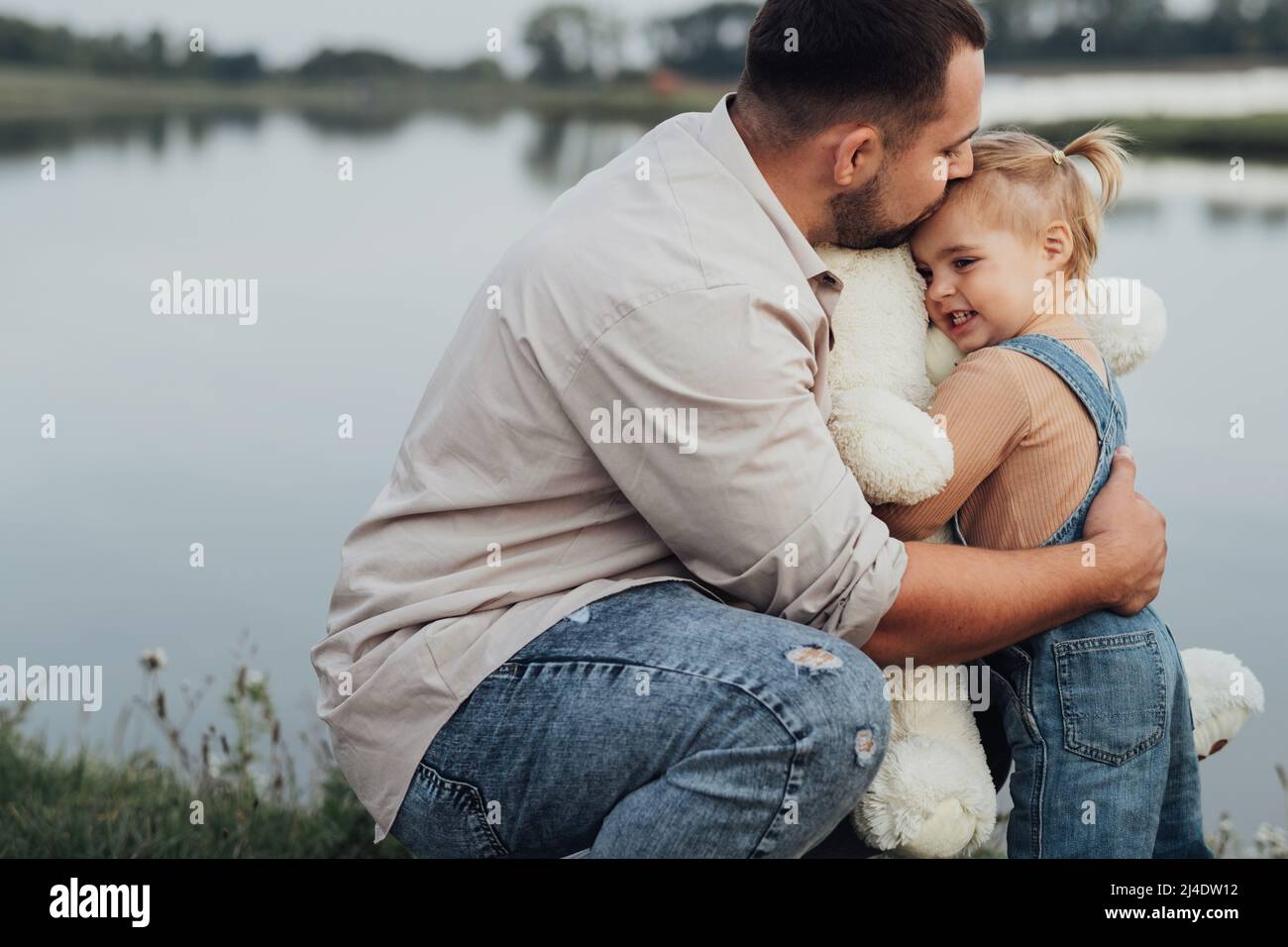 Young Father Hugging His Daughter and Gave Her Big Soft Toy Outdoors ...