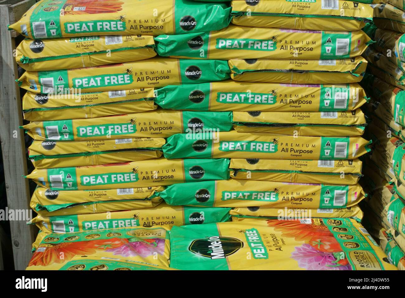 Stack of bags of no peat garden compost in garden centre UK Stock Photo ...