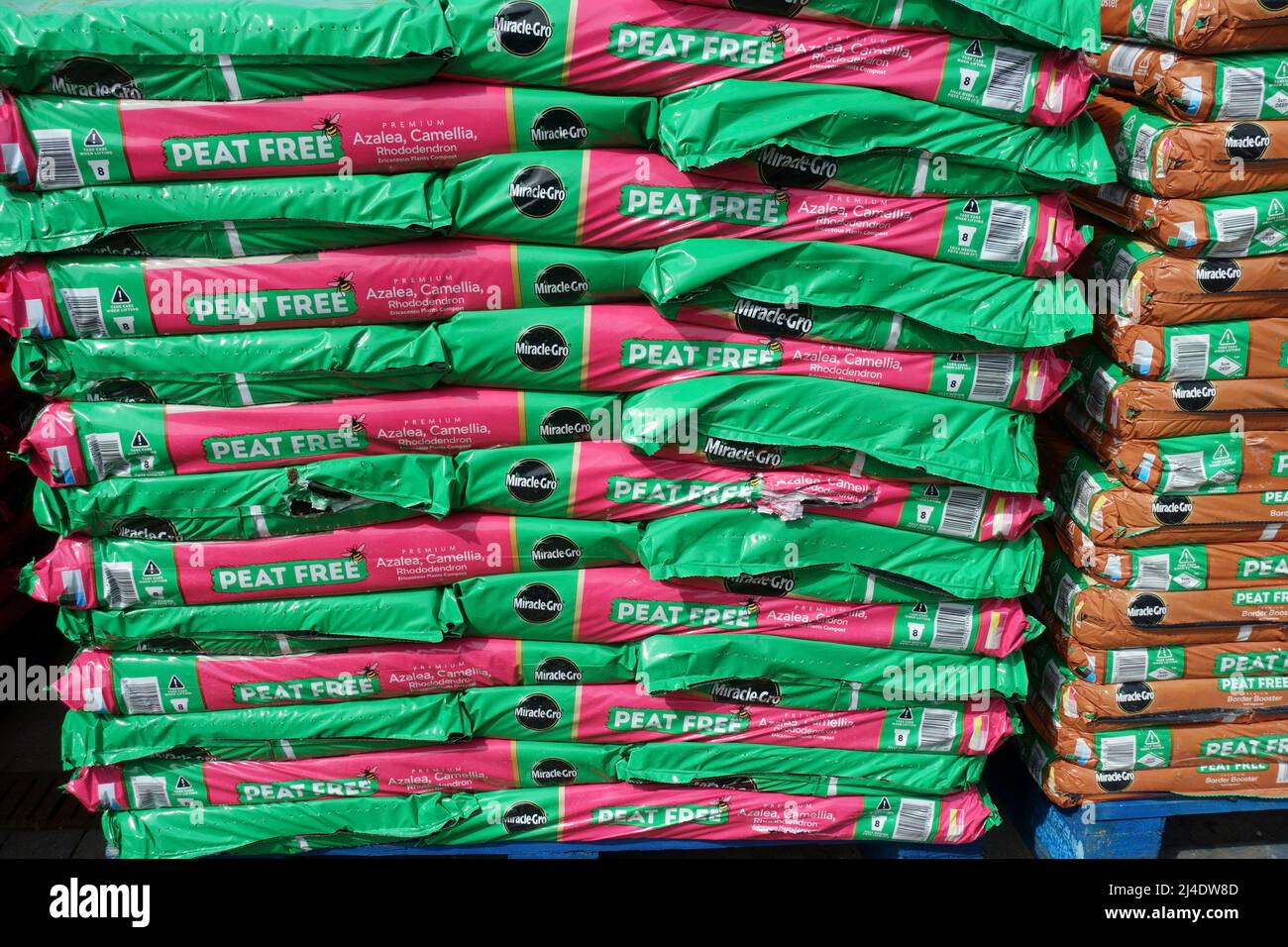 Stack of bags of no peat garden compost in garden centre UK Stock Photo ...