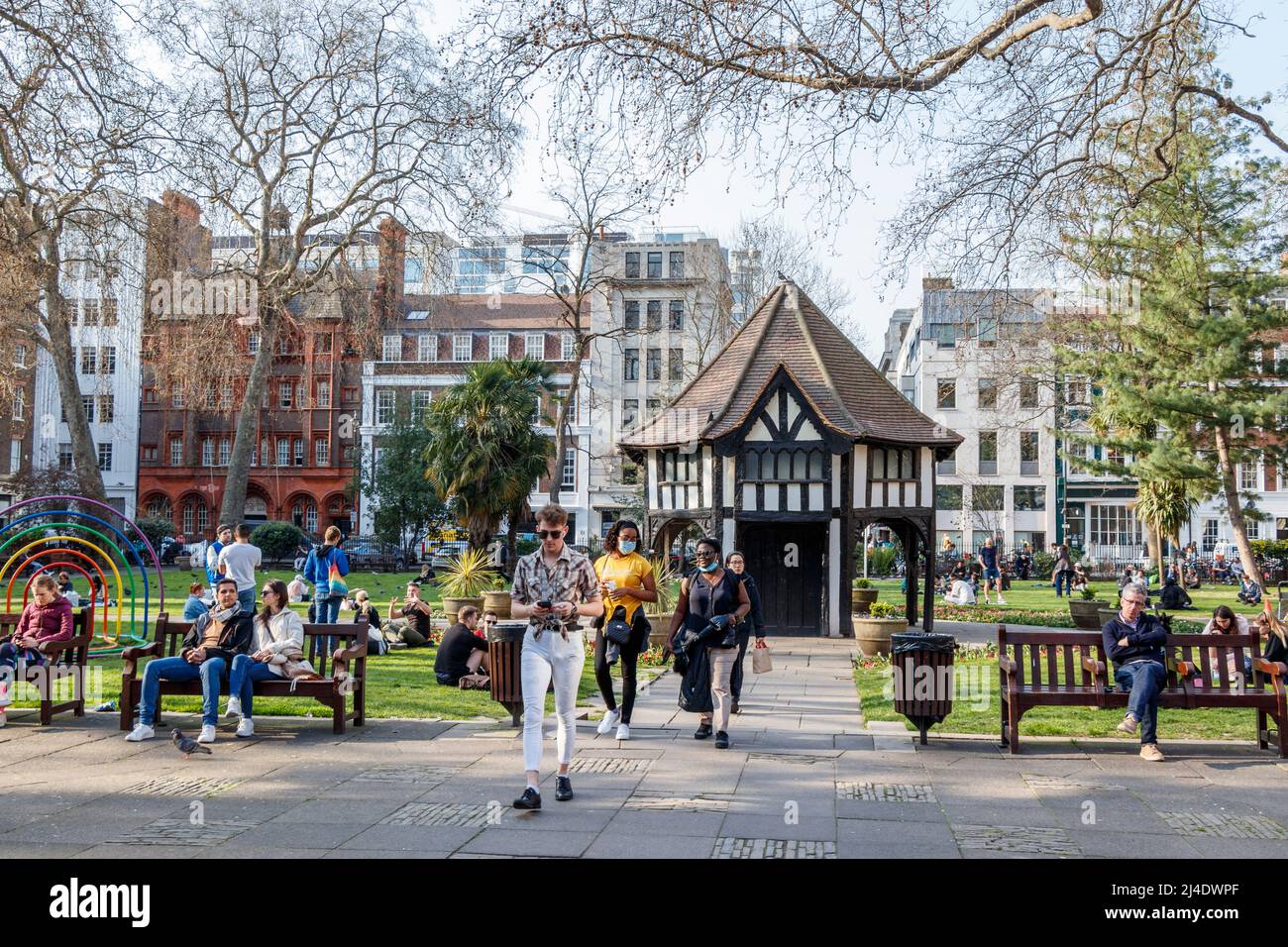 People enjoying the warmer weather arriving in the UK, Soho Square ...