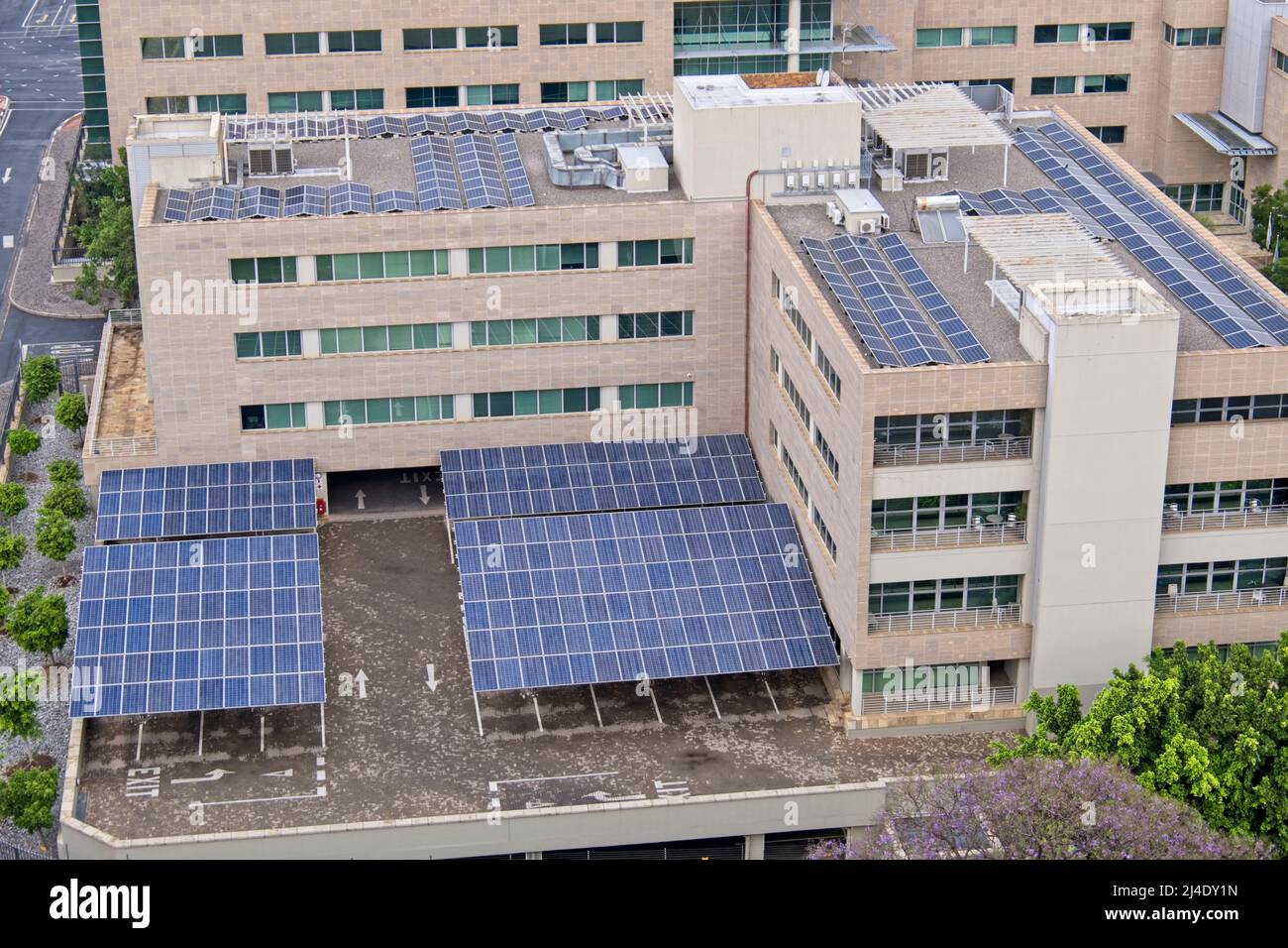 Solar panels on building rooftop and parking area Stock Photo - Alamy