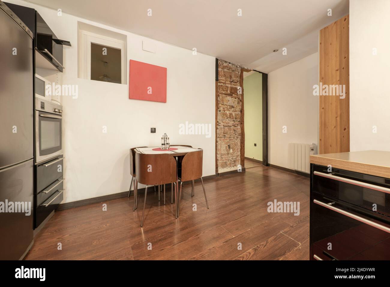 Kitchen with dining table with brown wooden design chairs, column of ...