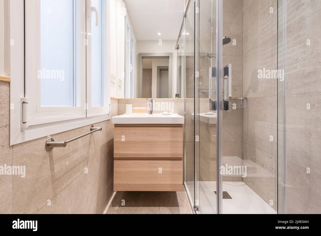 Bathroom with white aluminum window, frameless mirror embedded in the ...