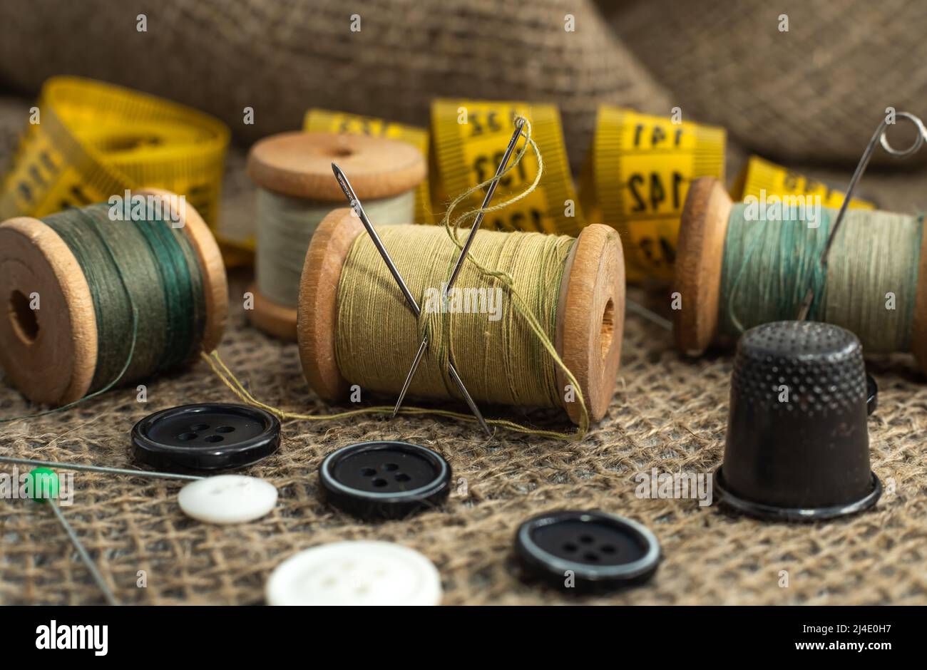 Retro tools for cutting and sewing. Needle with thread, thimble, sewing ...