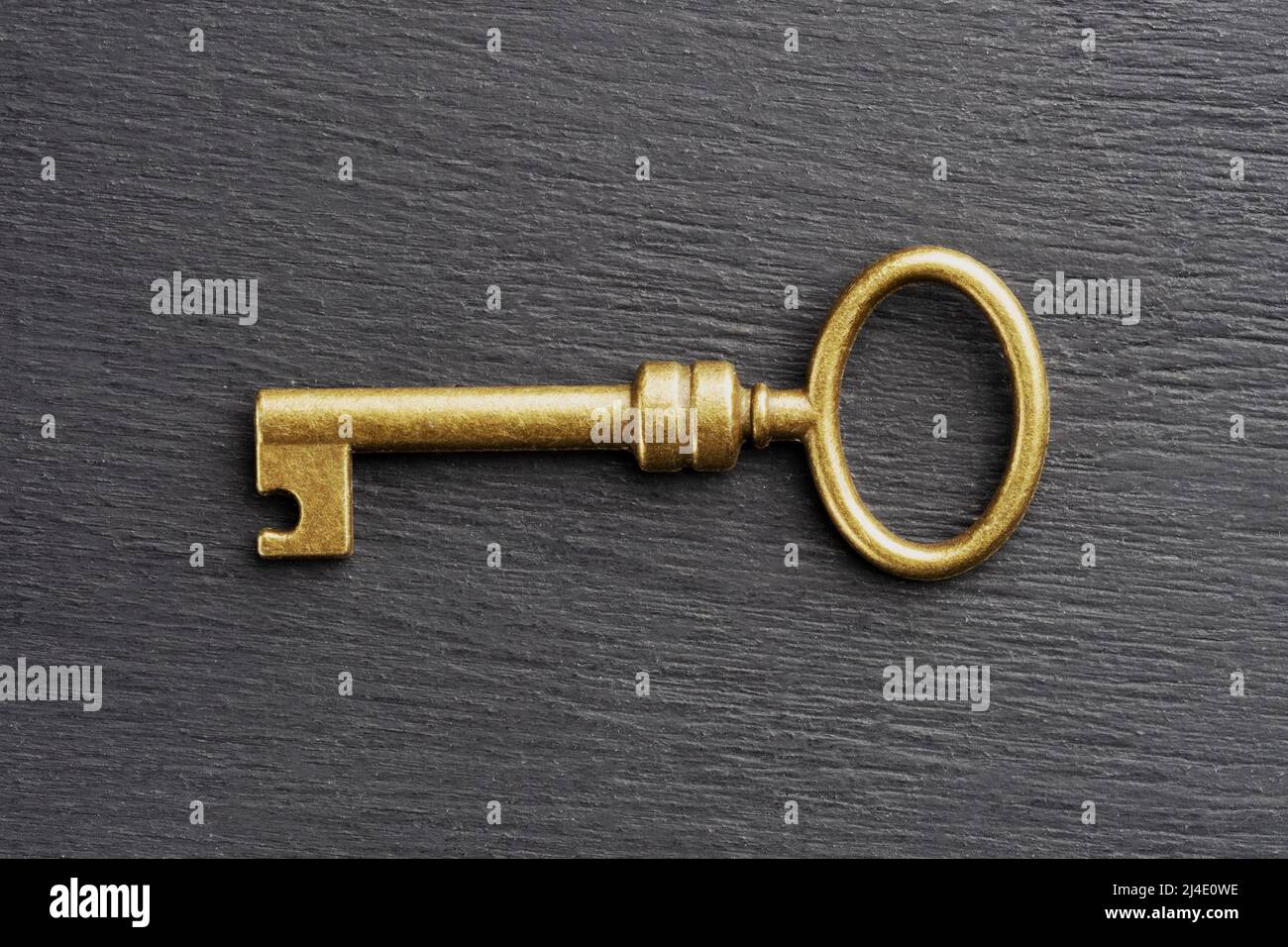 Bronze vintage antique key on black wooden background. Old keys concept ...