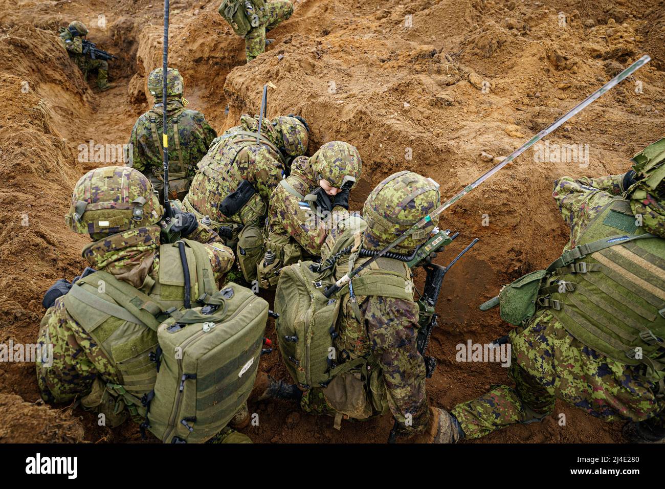 Estonian soldiers shelter from fire as they defend a dug-in position ...