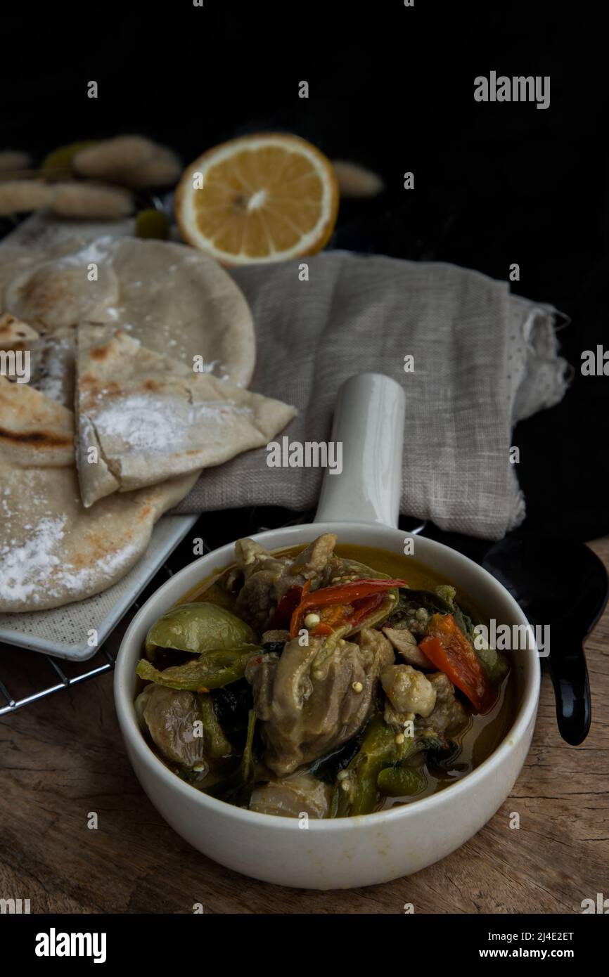 Homemade pita bread served with Green curry chicken (Kaeng khiao wan ...