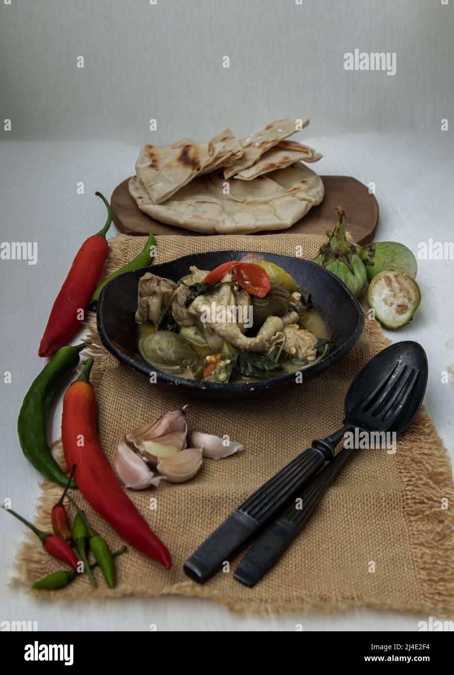 Homemade pita bread served with Green curry chicken (Kaeng khiao wan ...