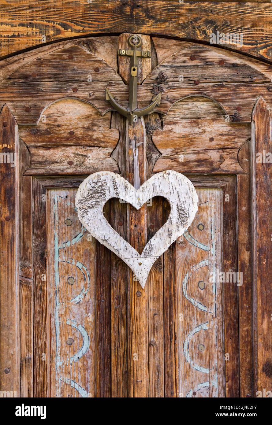 Heart shape deco hanging on a rustic wooden door Stock Photo - Alamy