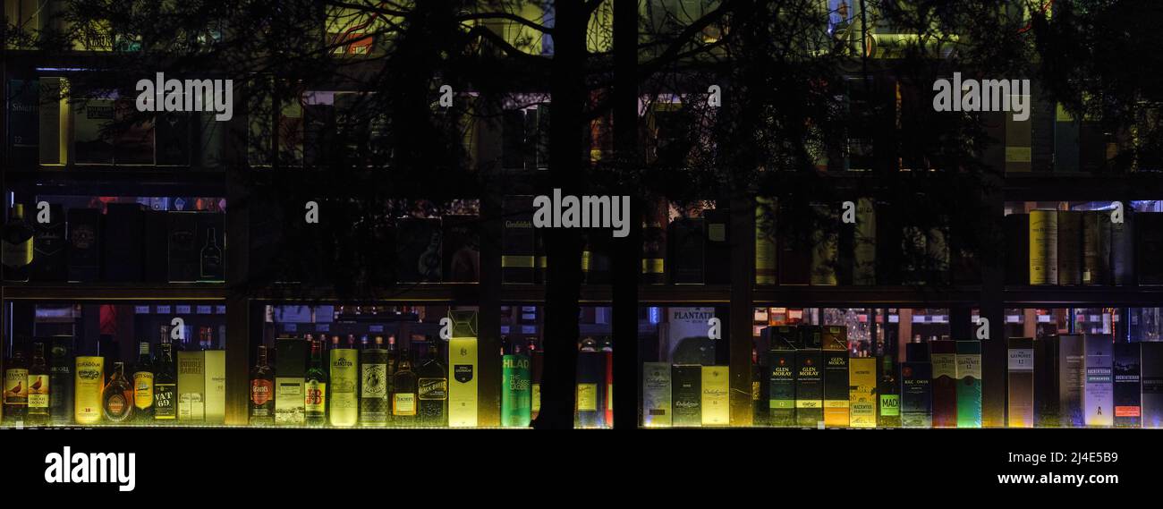 Alcohol shop window at night Stock Photo - Alamy