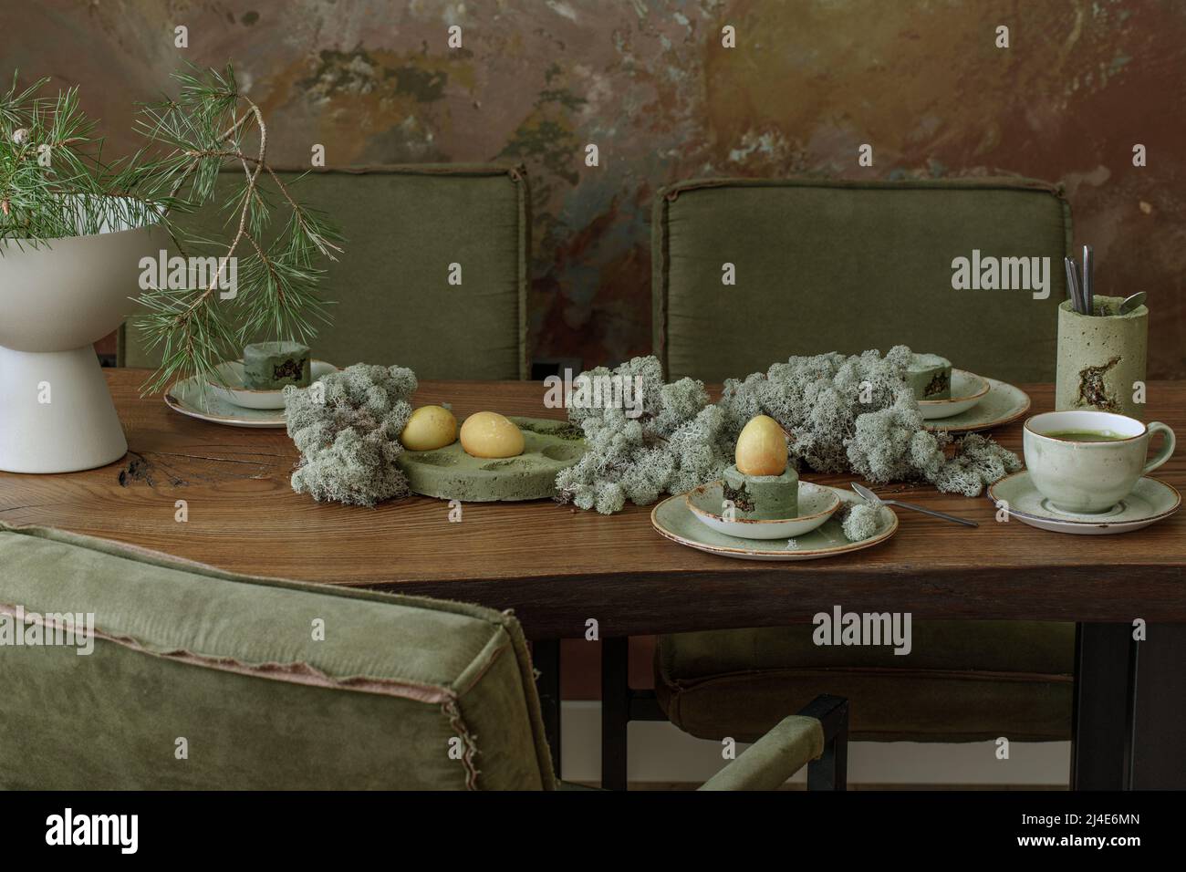 Table setting for Easter dinner decorated with forest moss, eggs ...