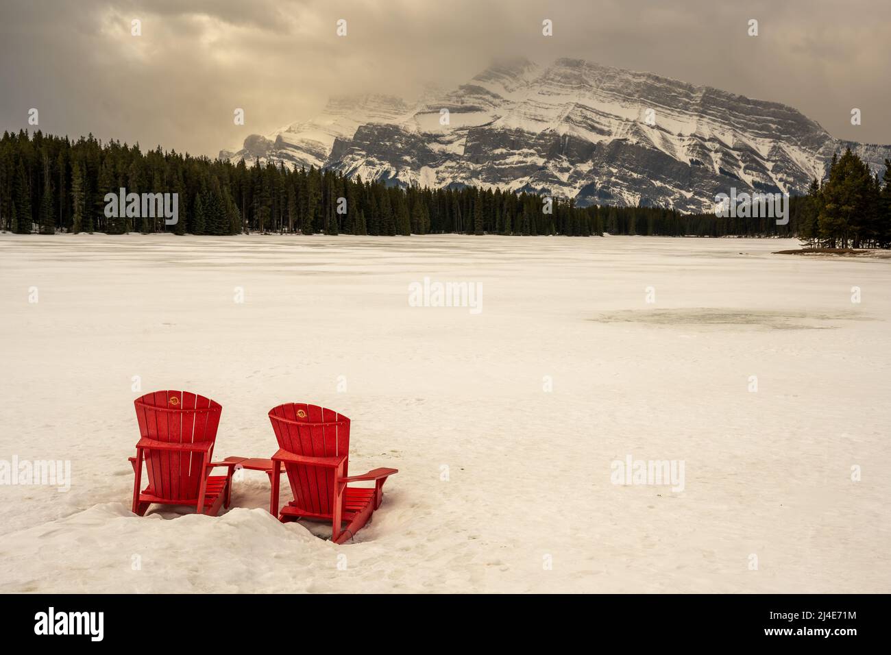 The iconic red chairs in the snow in front of the Two Jack lake in ...