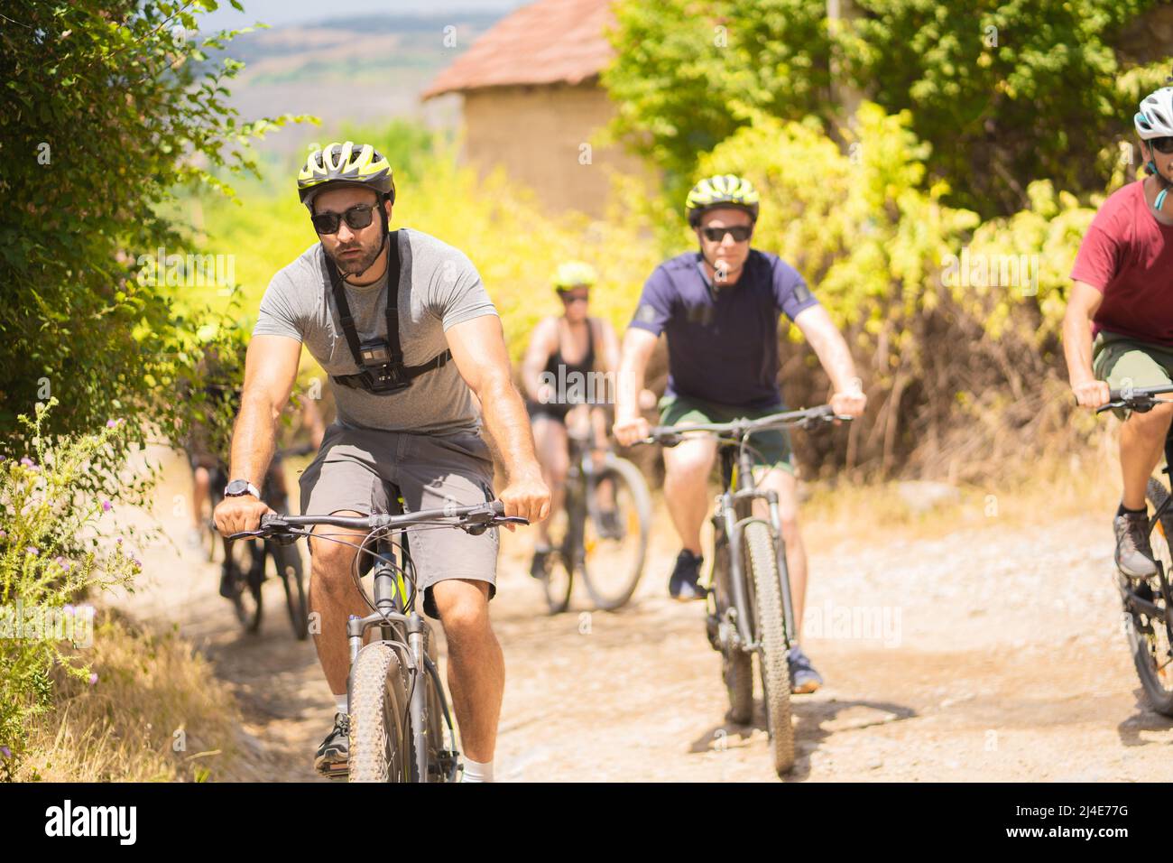 Group of friends are riding their bikes together while having a great ...