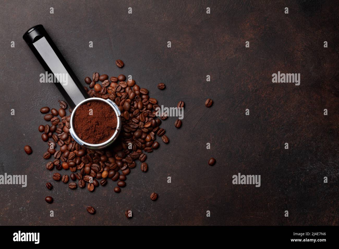 Roasted coffee beans and ground coffee in filter holder. Top view flat ...