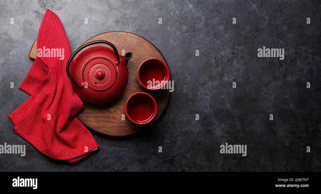 Tea cups and teapot on wooden board. Top view flat lay with copy space ...
