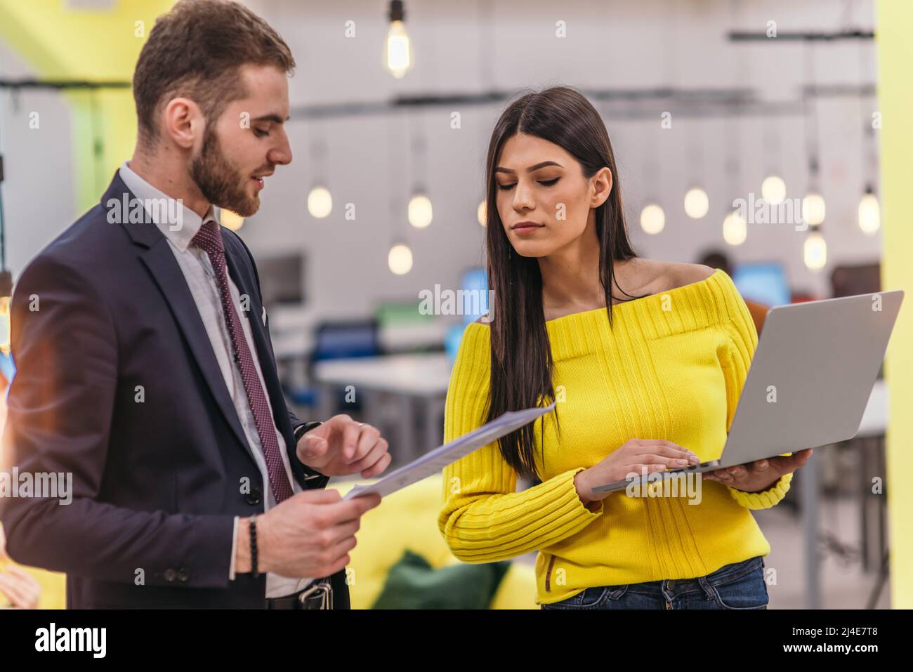 Manager explaining to his employee how to finish her tasks. Colleagues ...