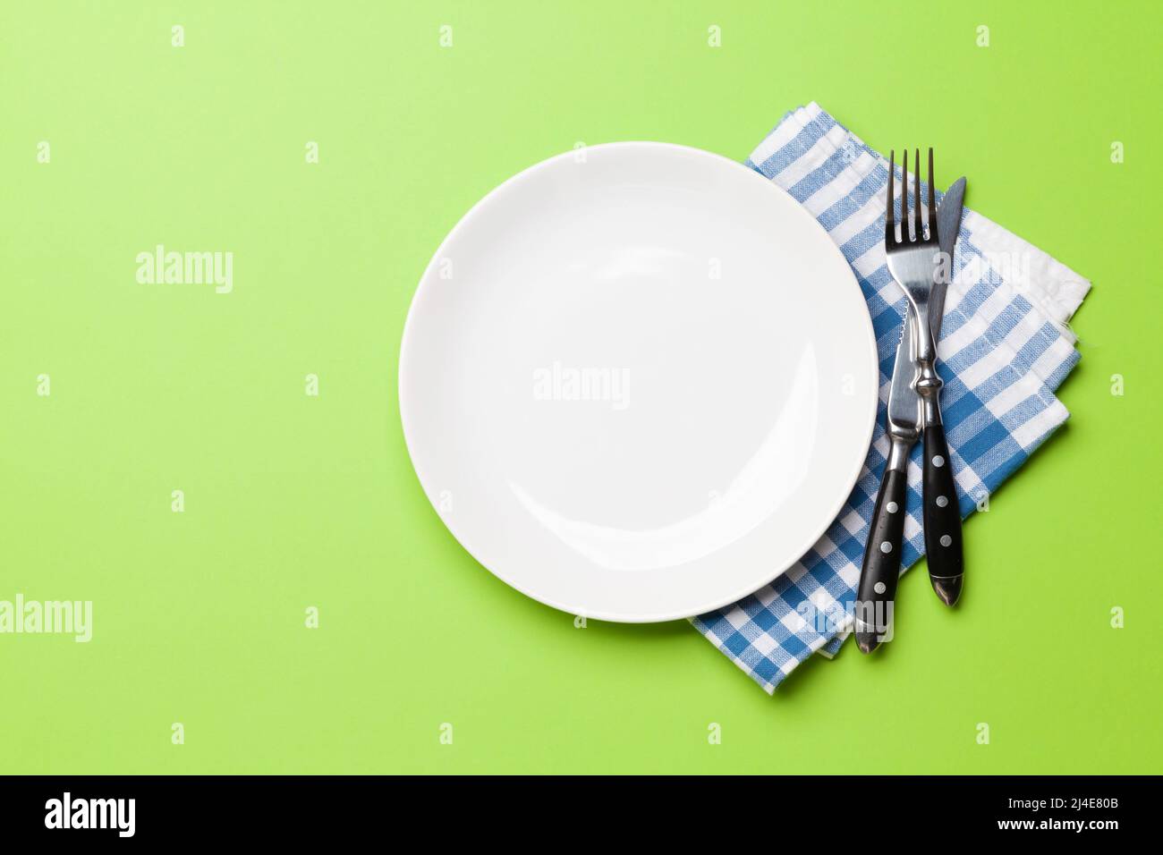 Empty plate and silverware. Top view flat lay with copy space. Template ...