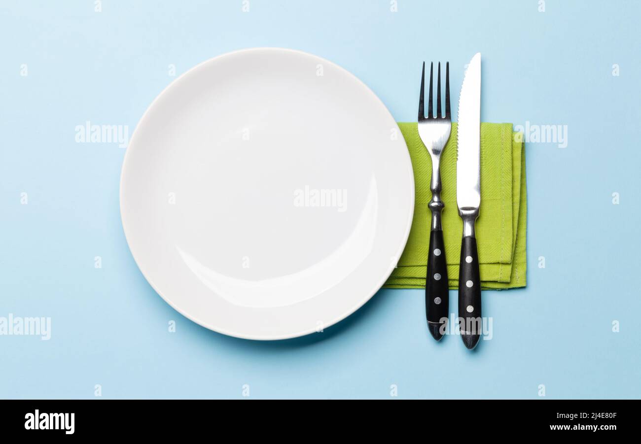 Empty plate and silverware. Top view flat lay with copy space. Template ...