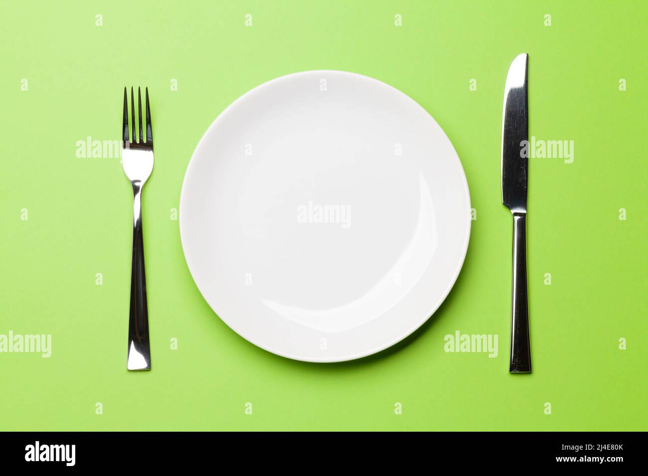 Empty plate and silverware. Top view flat lay with copy space. Template ...