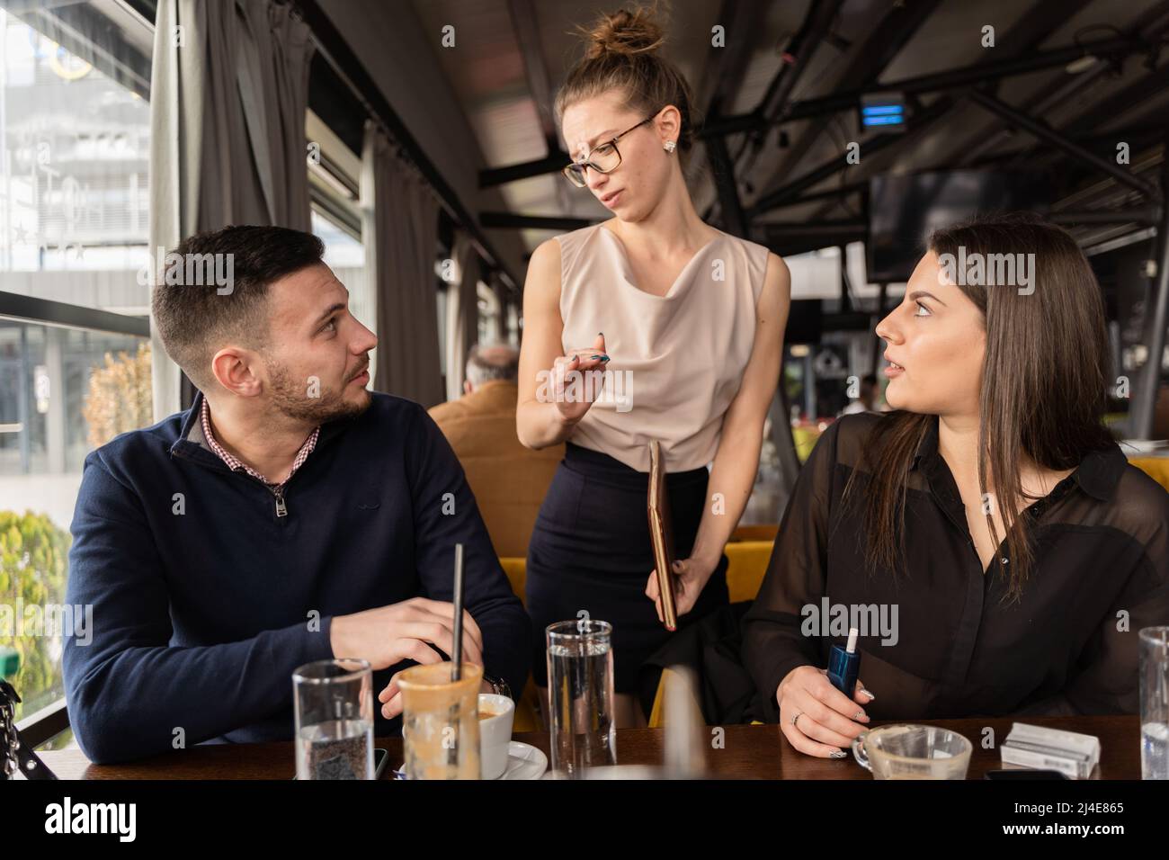 Group of young business people are having a serious talk about their ...