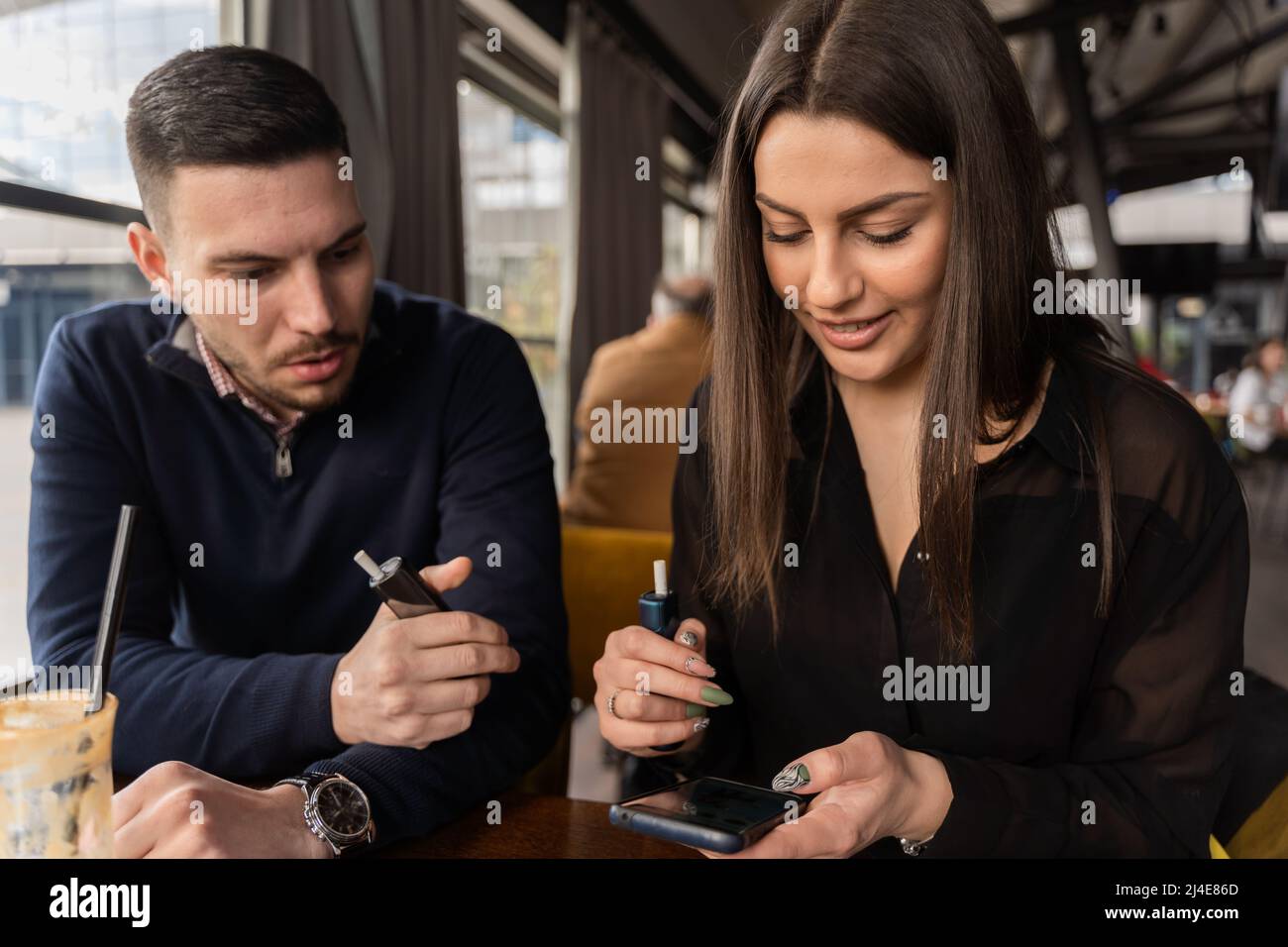 Amazing and attractive young business people are smoking cigarettes and ...