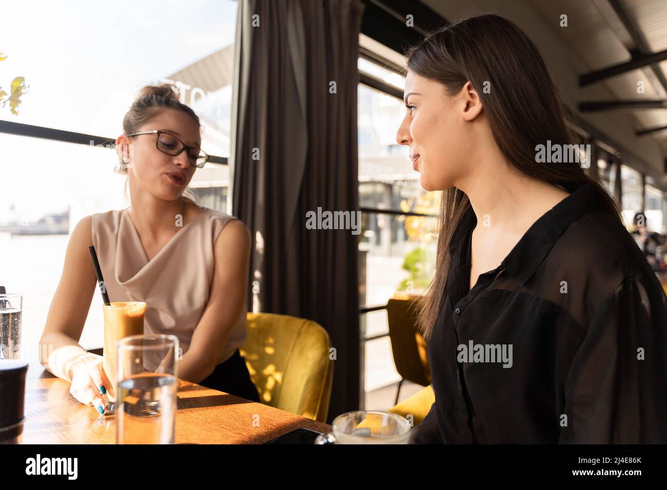 Two amazing and attractive business partners are smiling and talking ...