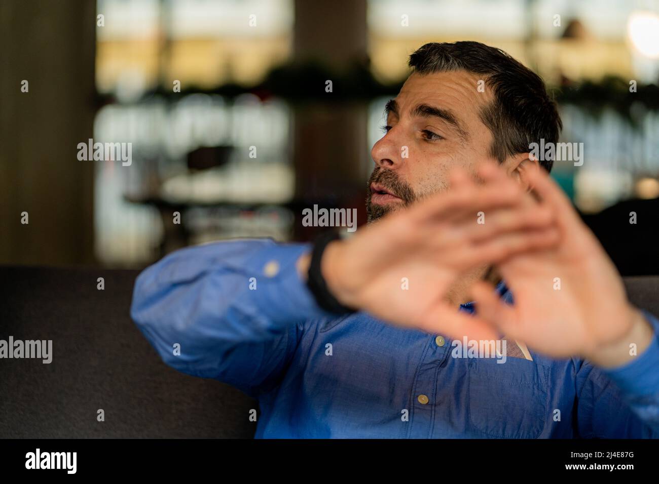 Amazing and handsome businessman is talking to his co workers while ...