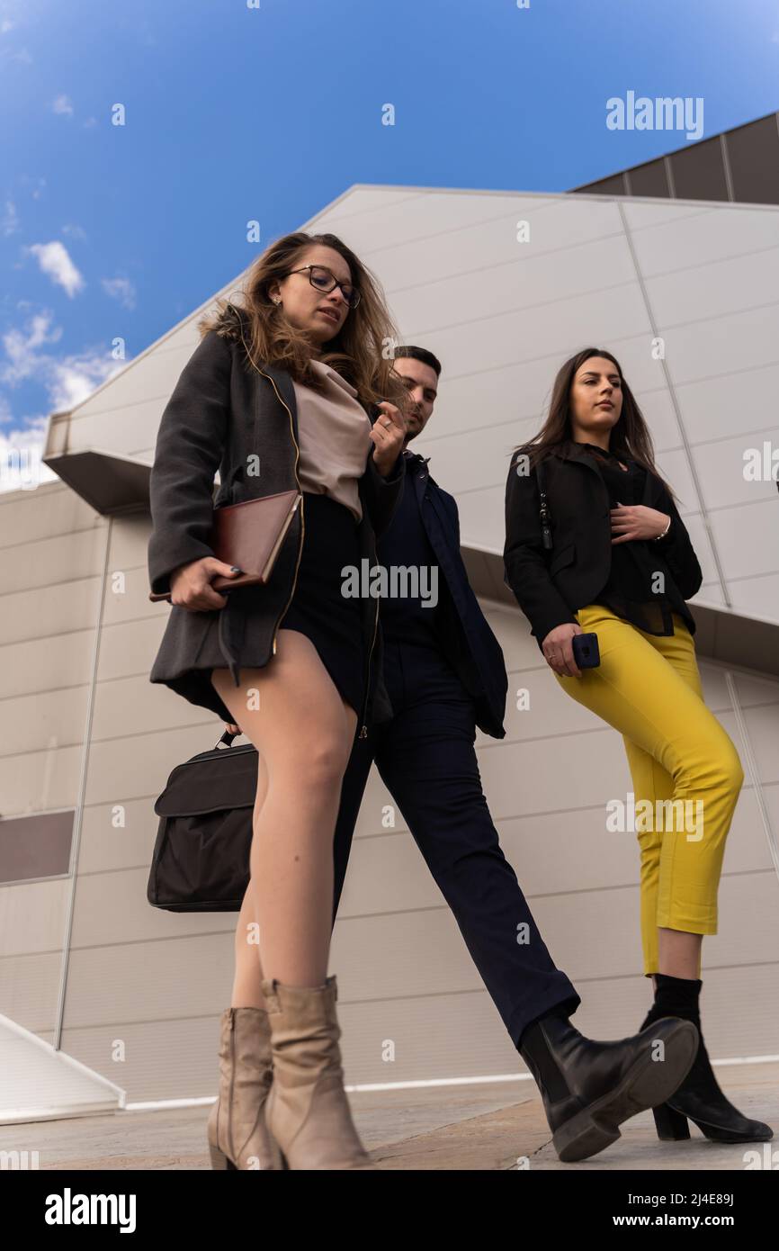 Group of young business people are talking and walking all together ...