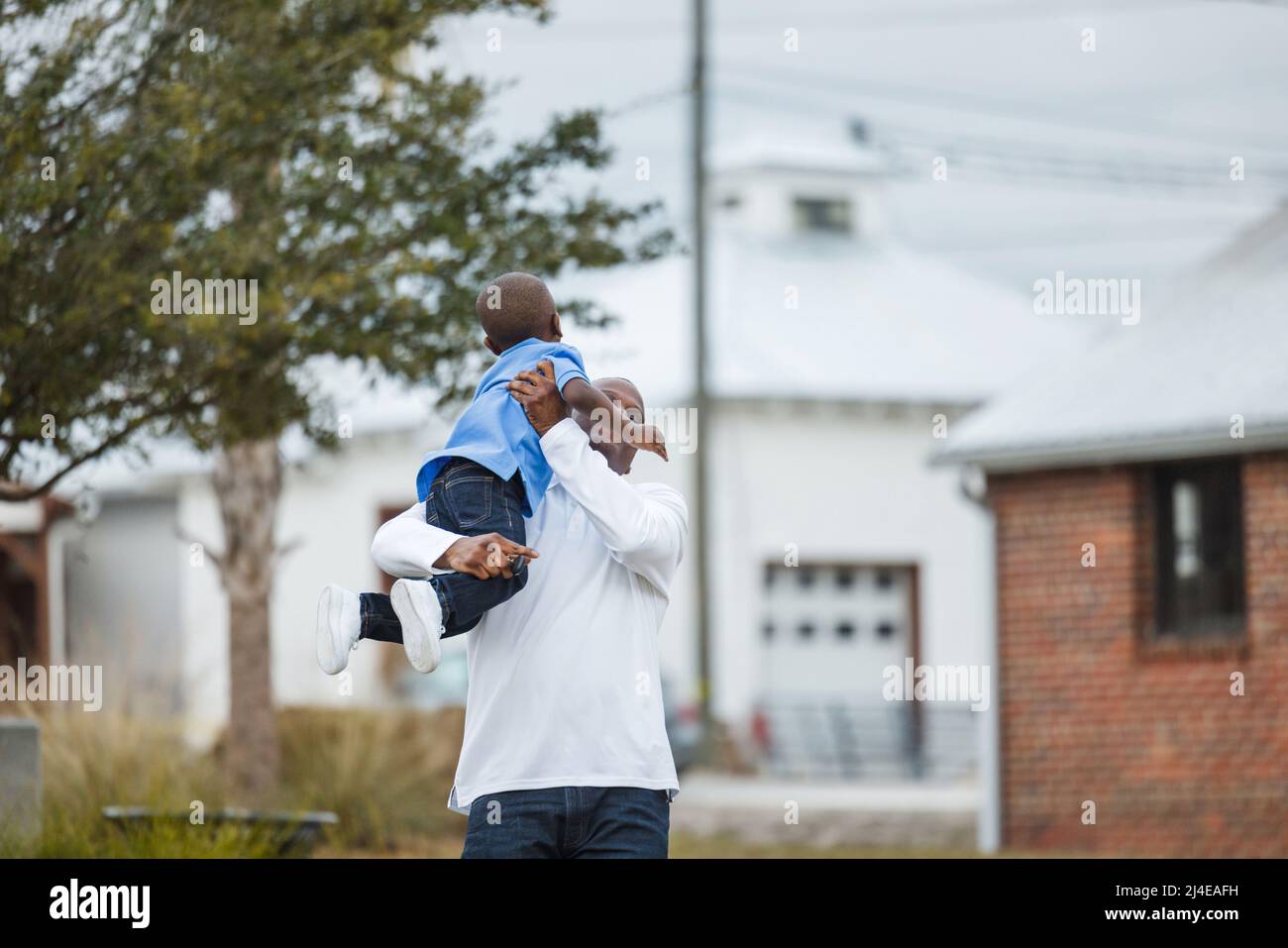 A preschool age little boy being picked up by his dad Stock Photo - Alamy