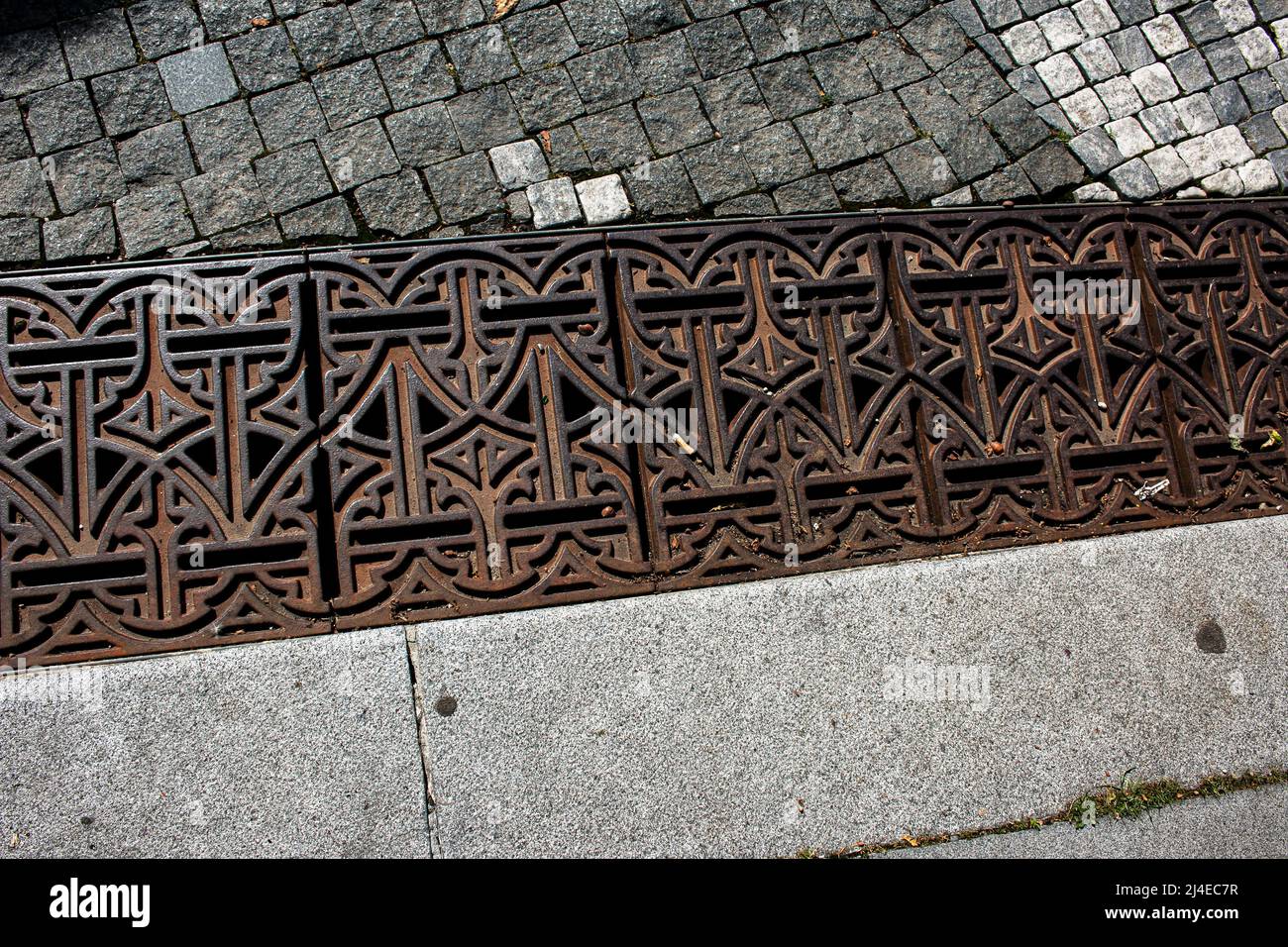 Cast iron grille over the drain. Cast iron grille over the drainage ...
