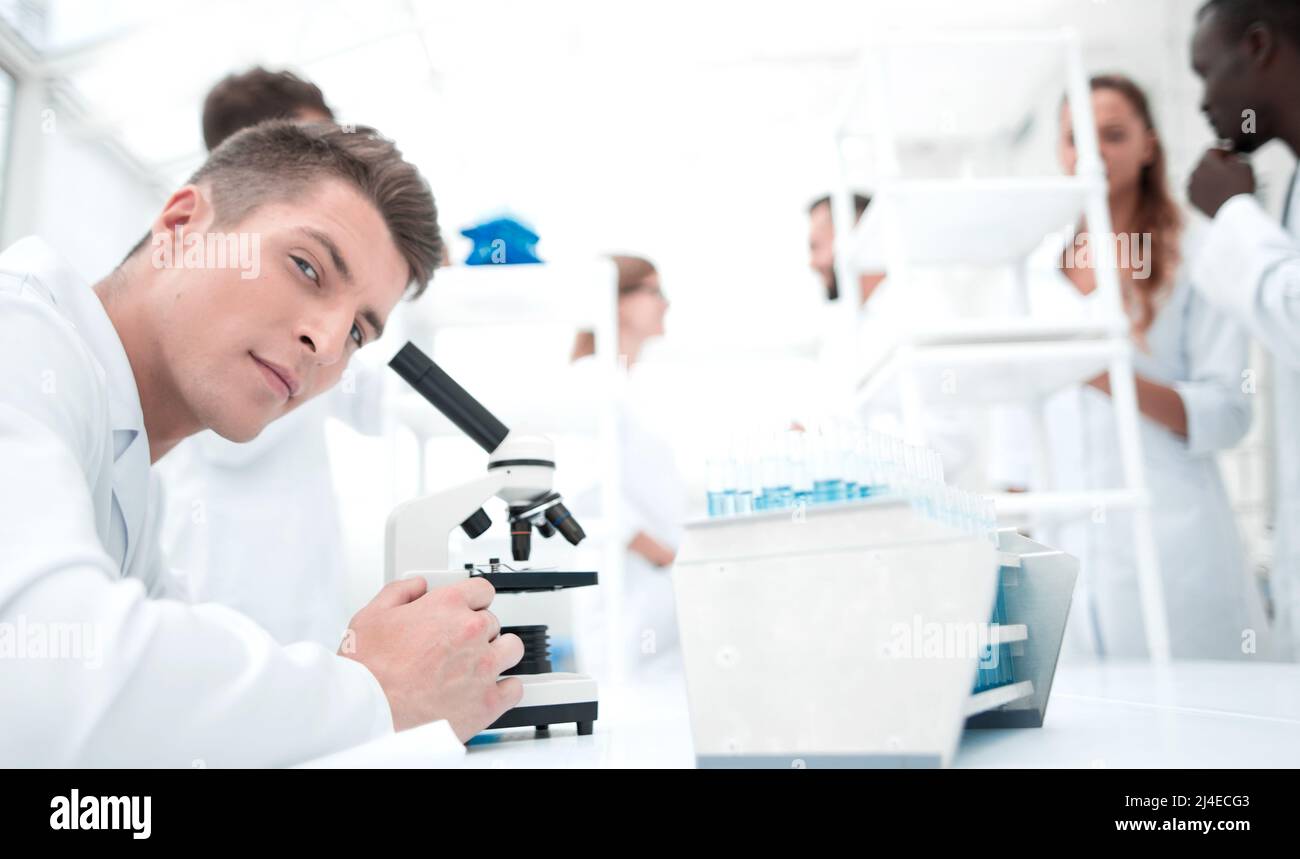 cheerful laboratory worker using microscope in lab Stock Photo - Alamy