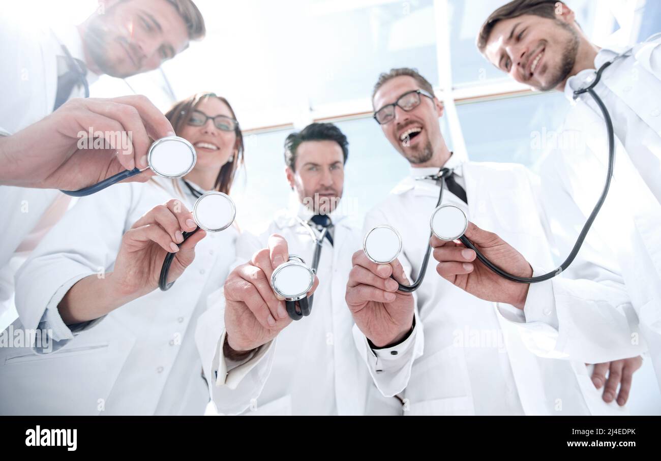bottom view.a group of doctors have put their stethoscopes together ...