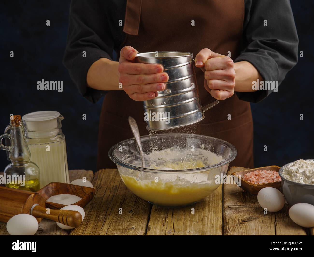 Cooking dough by the hands of a professional chef. The chef sifts the ...
