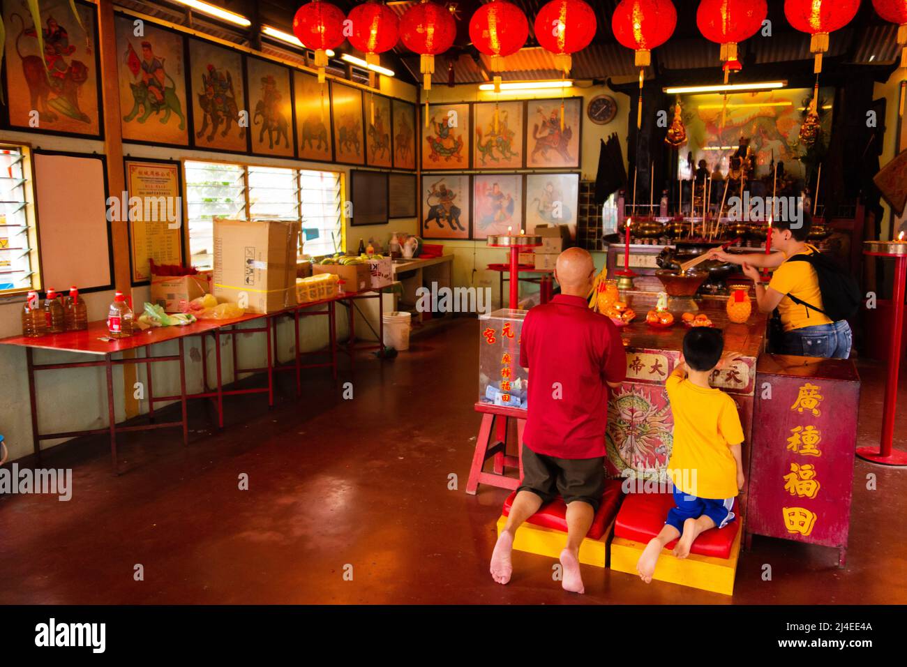 GEORGE TOWN, MALASIA – JANUARY 31; 2020 father and son kneeling in a ...
