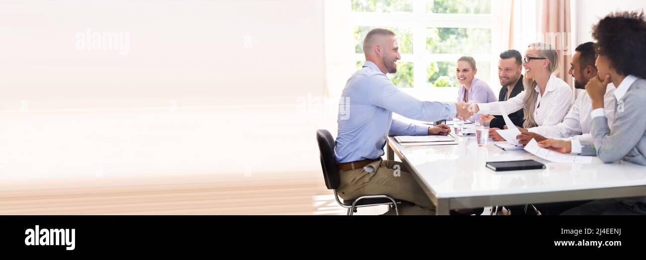 Smiling Young Man Shaking Hands With Female At Interview Stock Photo ...