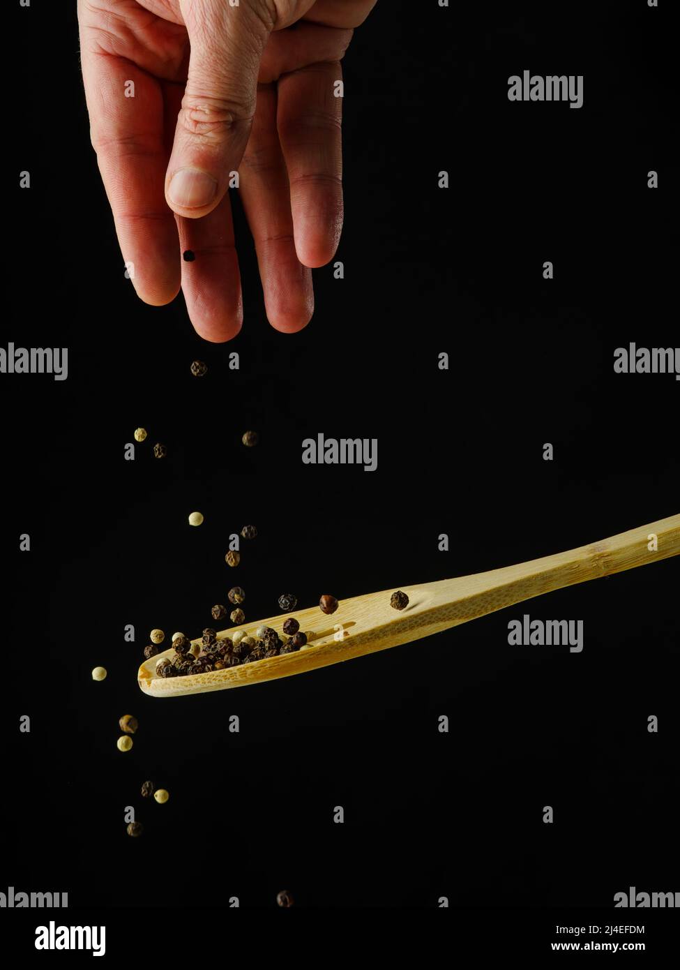 Fragrant spices, seasonings in a frozen flight from a female hand fall ...