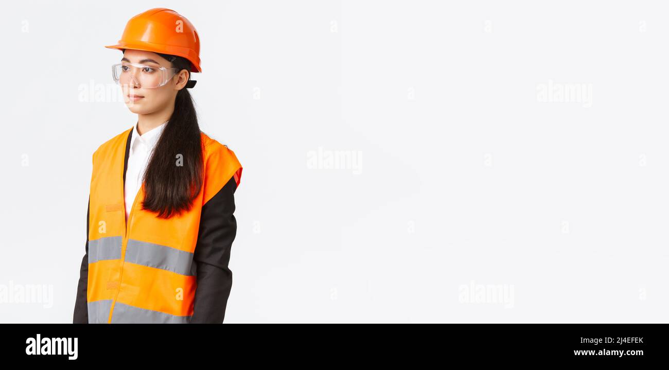 Profile of serious asian female businesswoman inspecting construction ...