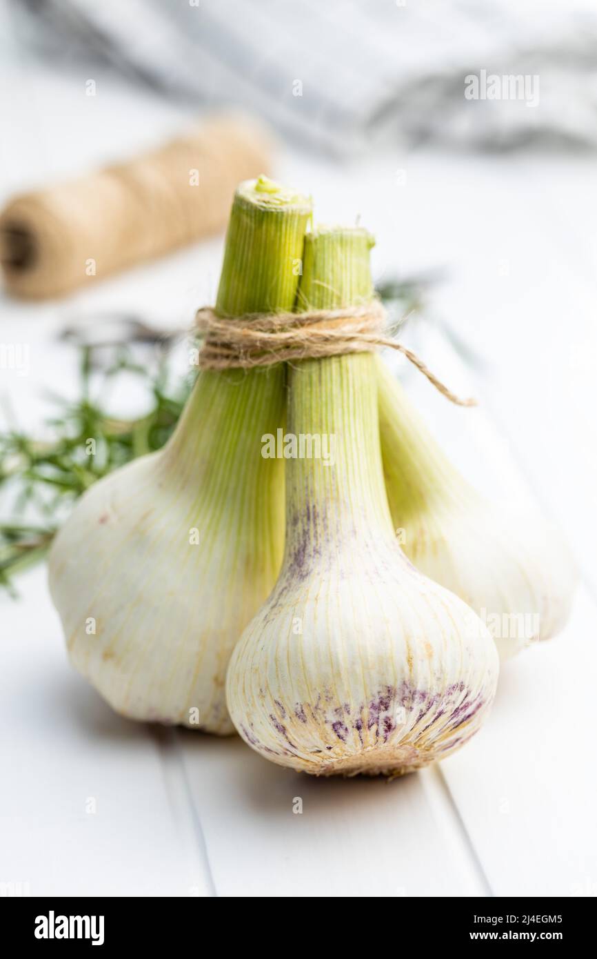 Whole garlic bulb. Fresh white garlic on a white table Stock Photo - Alamy