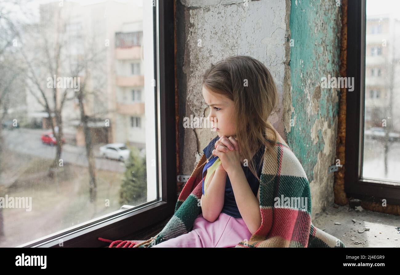 a little Ukrainian girl prays for the freedom of Ukraine holding ...