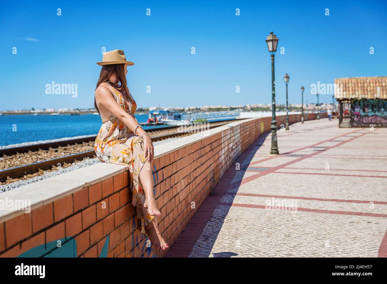 Woman on walk sitting hi-res stock photography and images - Alamy