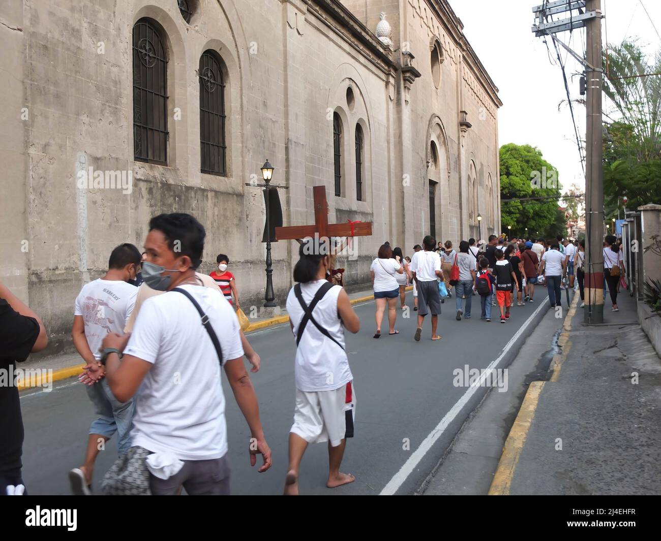 Manila, Philippines. 14th Apr, 2022. A devotee carries a replica of Christ Crucifixion as she ...