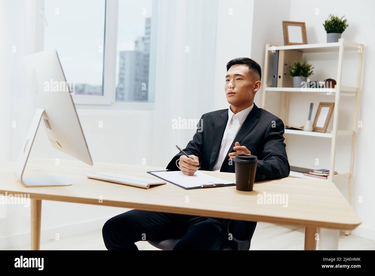 man sitting at a desk in front of a computer emotions Workspace Stock ...