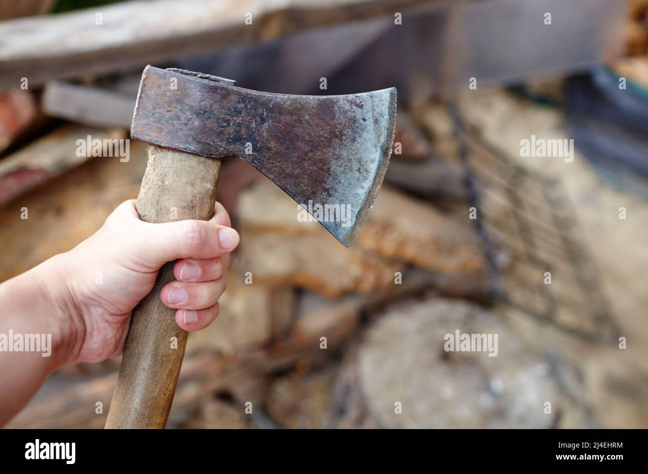 Man holding axe. Ax in hand. A strong man holds an ax in his hands ...