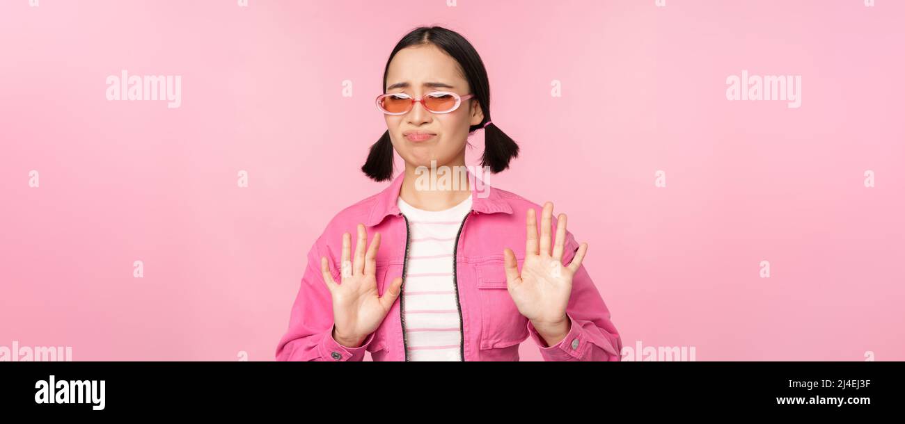 No thanks. Disgusted asian girl in sunglasses, rejecting smth, shaking ...