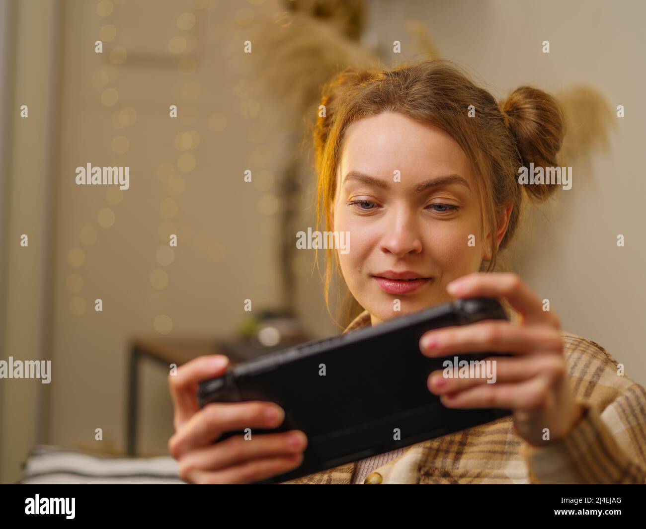 A gamer girl enthusiastically plays a video game online with friends on ...