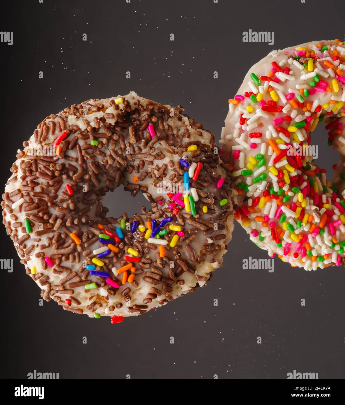 Macro shot. Two delicious donuts in sugar glaze and multi-colored ...