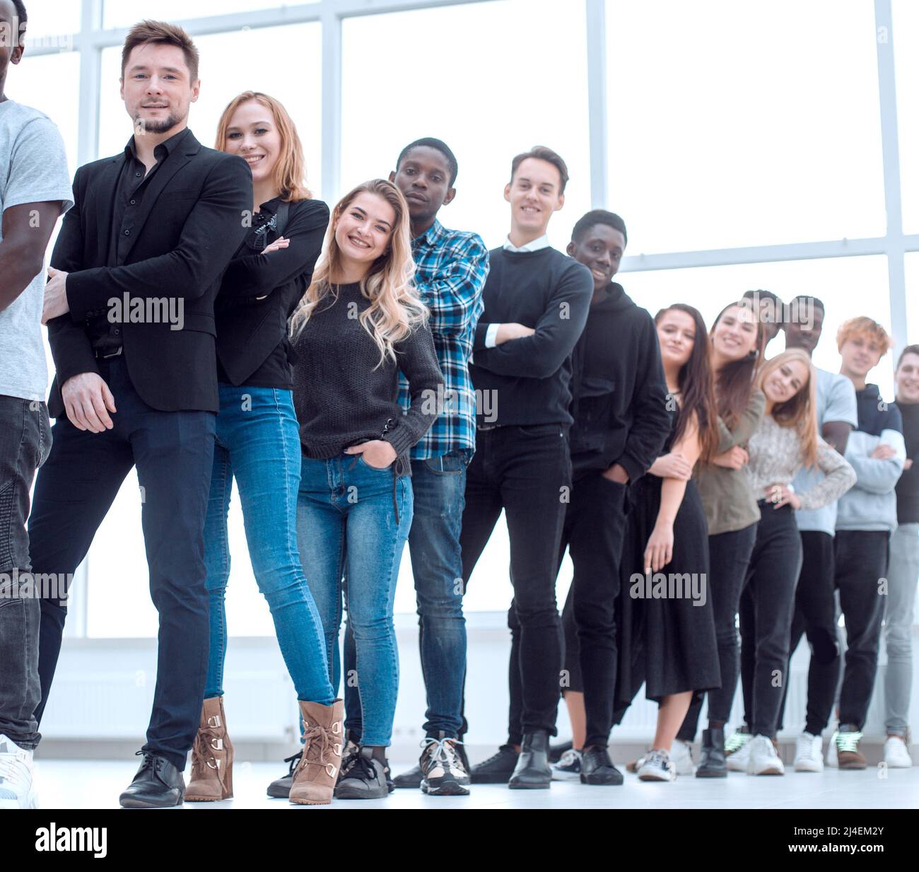 full length . diverse young people standing in line Stock Photo - Alamy