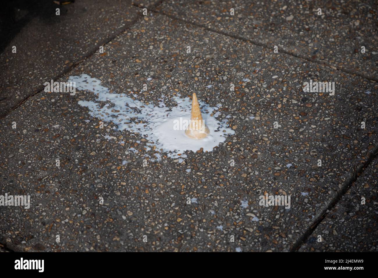 Dropped Ice Cream Cone Melts on Sidewalk Stock Photo - Alamy