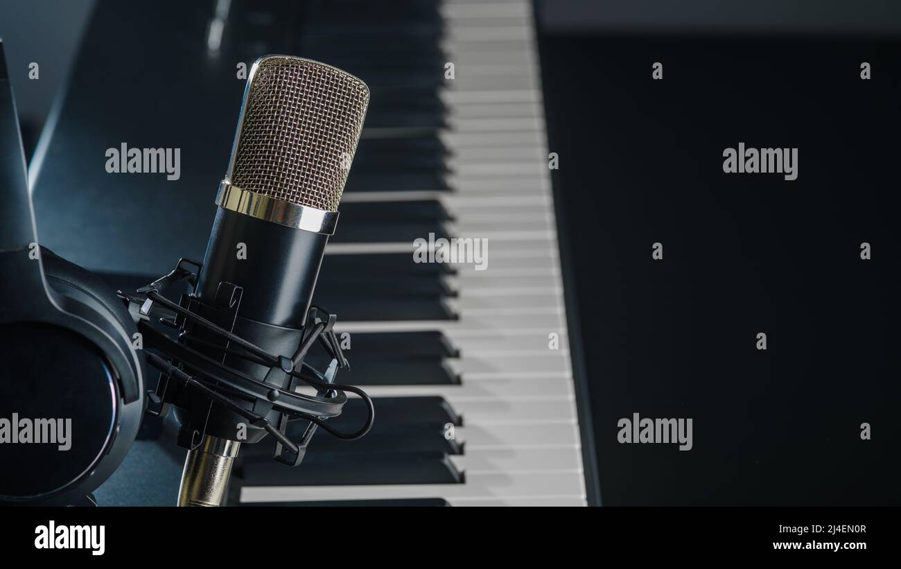 Close-up. Professional microphone and midi keyboard. Recording studio ...