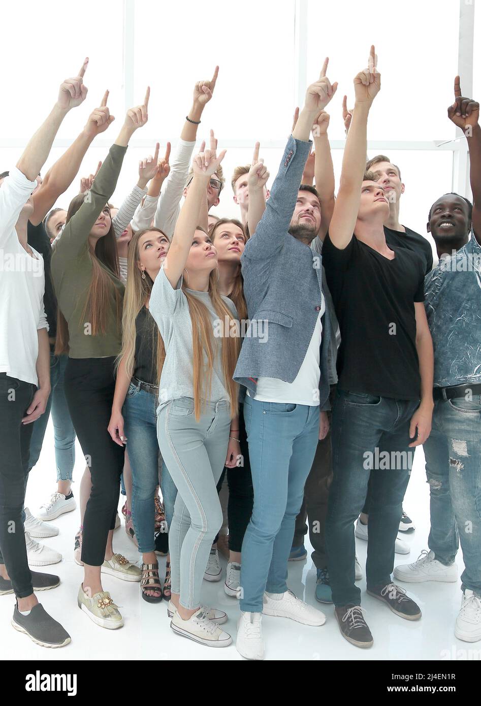 group of diverse young people pointing upwards Stock Photo - Alamy